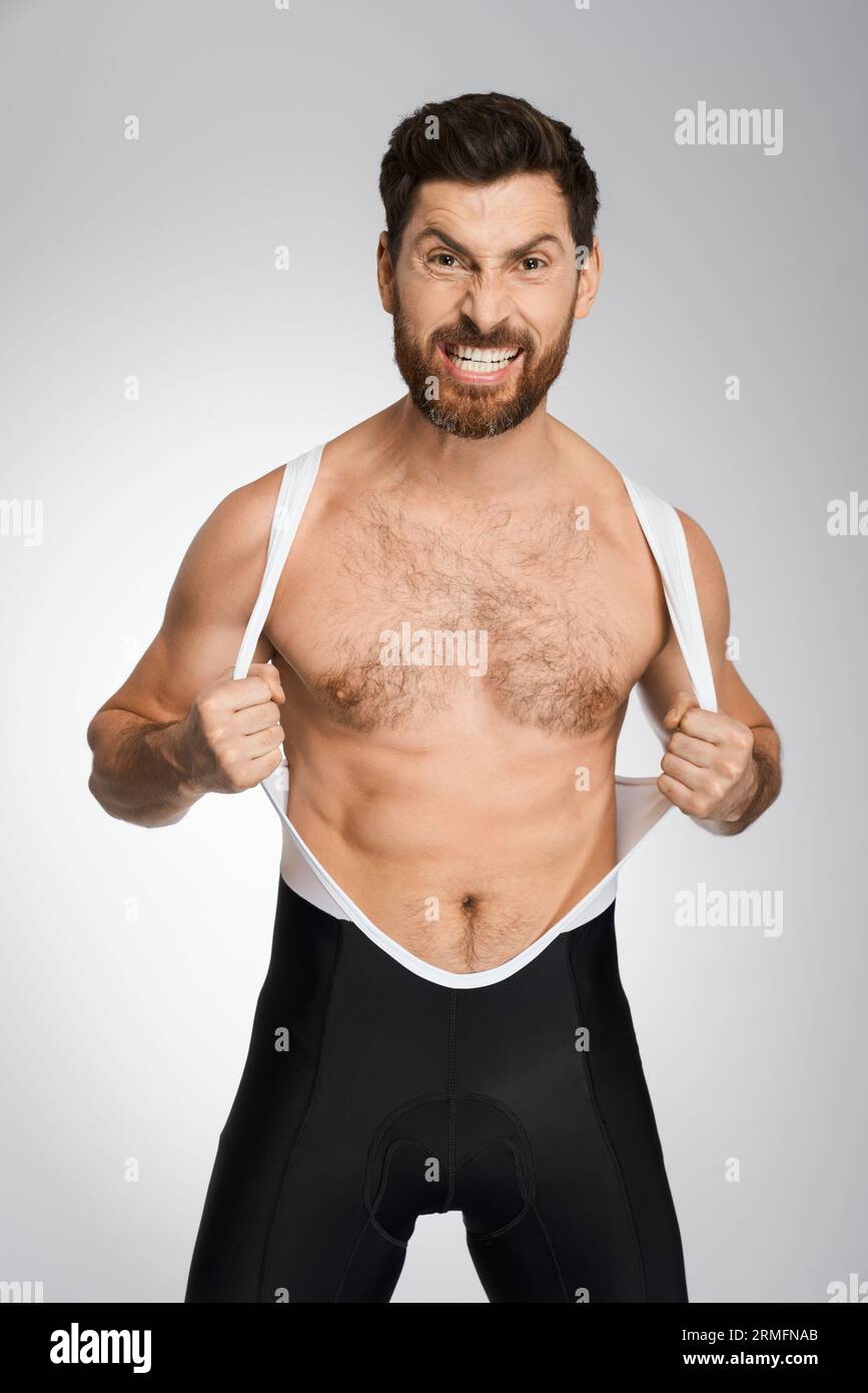 Aggressive caucasian wrestler in black and white singlet, while posing ...