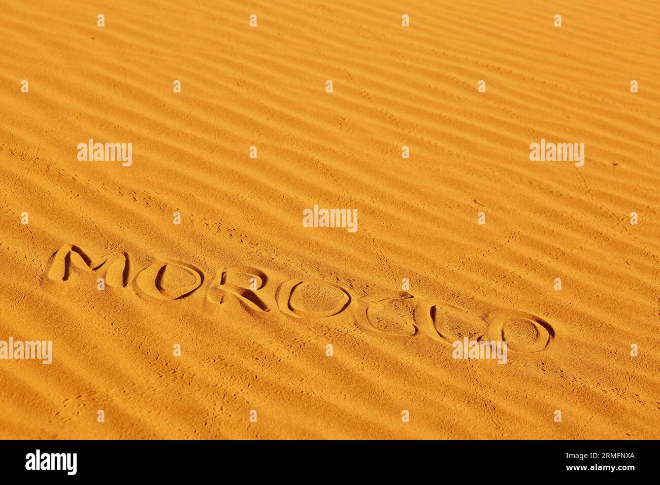 Word Morocco written on the sand in sand dunes in the Sahara Desert ...