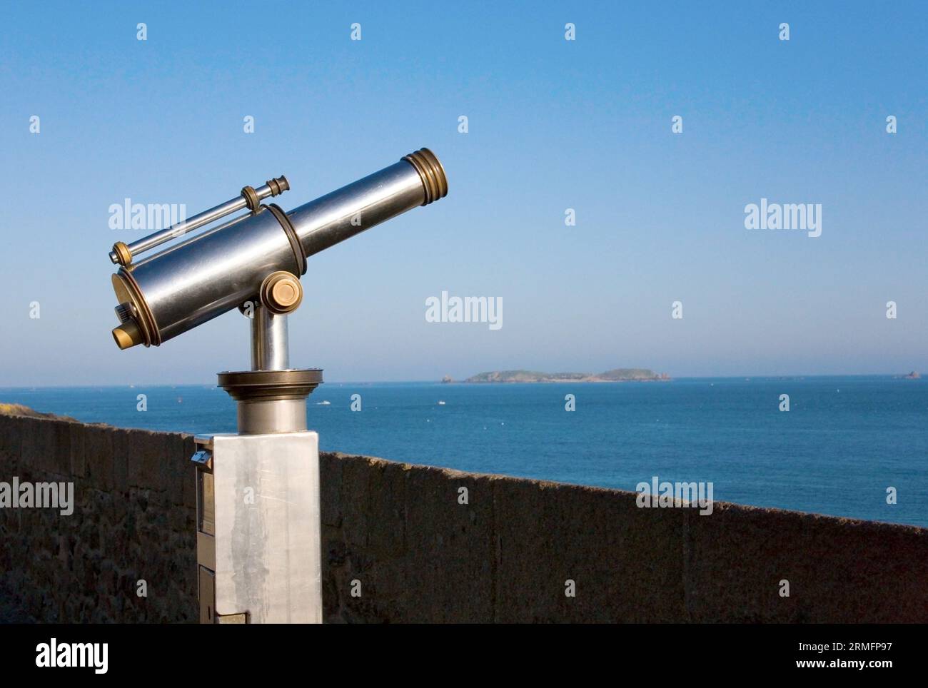 Coin operated viewfinder telescope overlooking sea shore Stock Photo ...