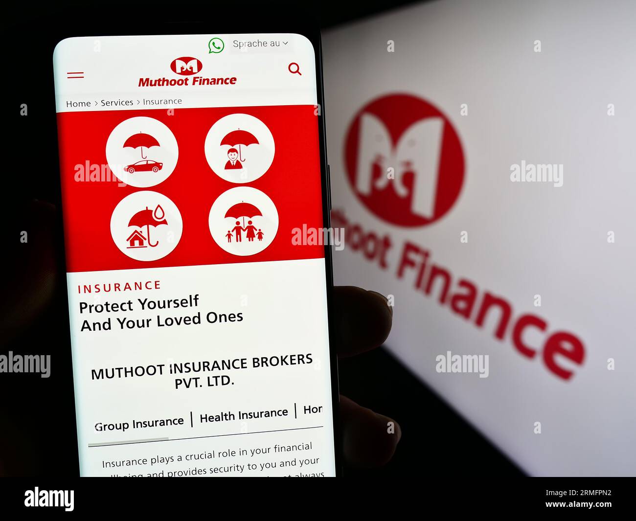 Person holding cellphone with web page of Indian financial company ...