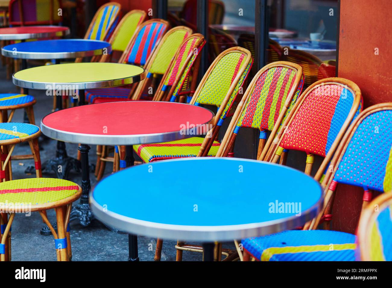 Colorful tables and chairs of empty outdoor cafe in Paris, France Stock ...