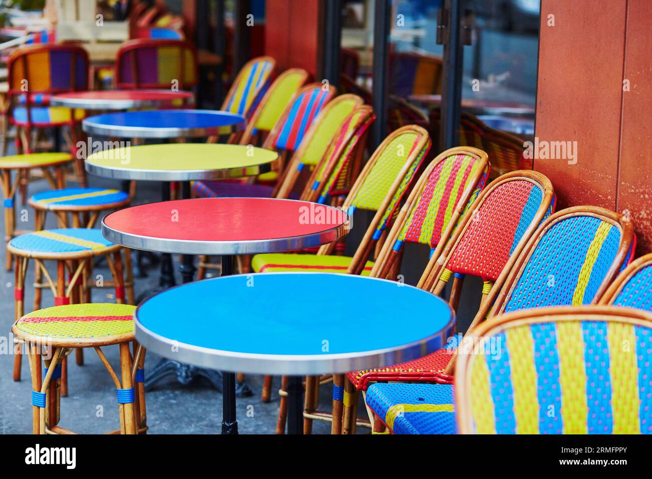 Colorful tables and chairs of empty outdoor cafe in Paris, France Stock ...