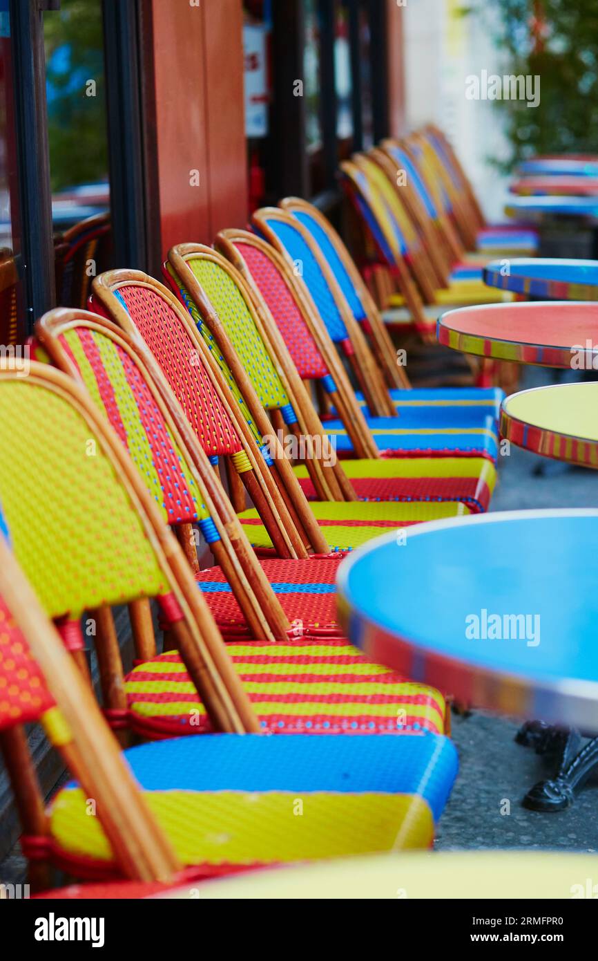 Colorful tables and chairs of empty outdoor cafe in Paris, France Stock ...