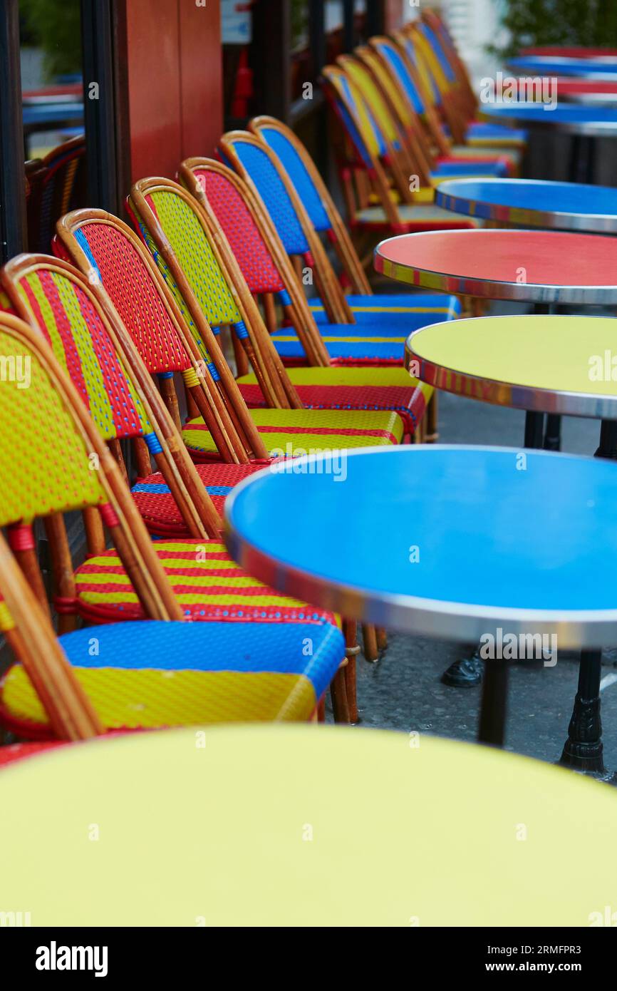 Colorful tables and chairs of empty outdoor cafe in Paris, France Stock ...
