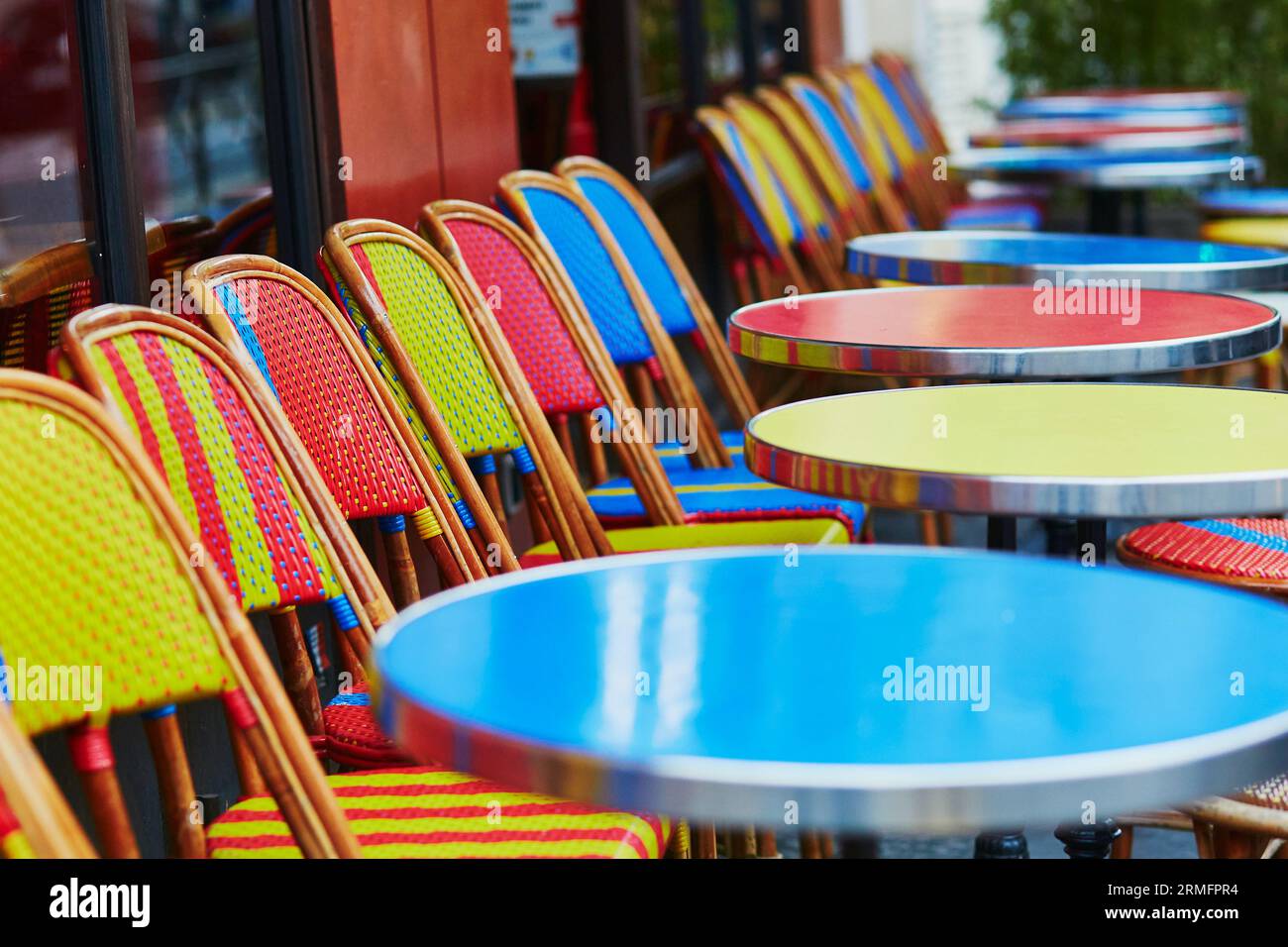 Colorful tables and chairs of empty outdoor cafe in Paris, France Stock ...