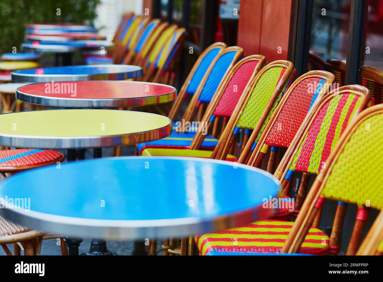 Colorful tables and chairs of empty outdoor cafe in Paris, France Stock ...