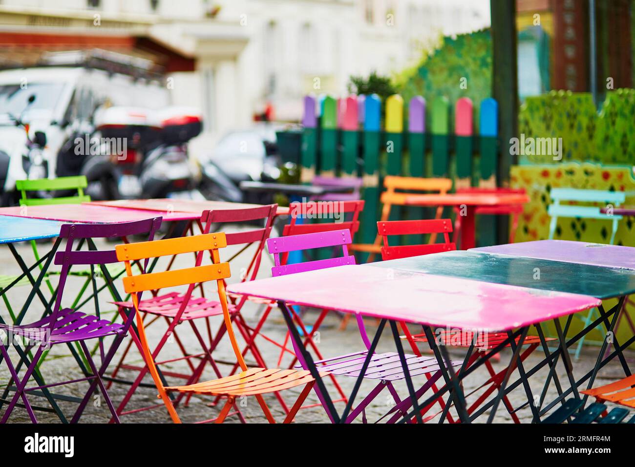 Bright colorful tables of an empty Parisian outdoor cafe on Montmartre ...