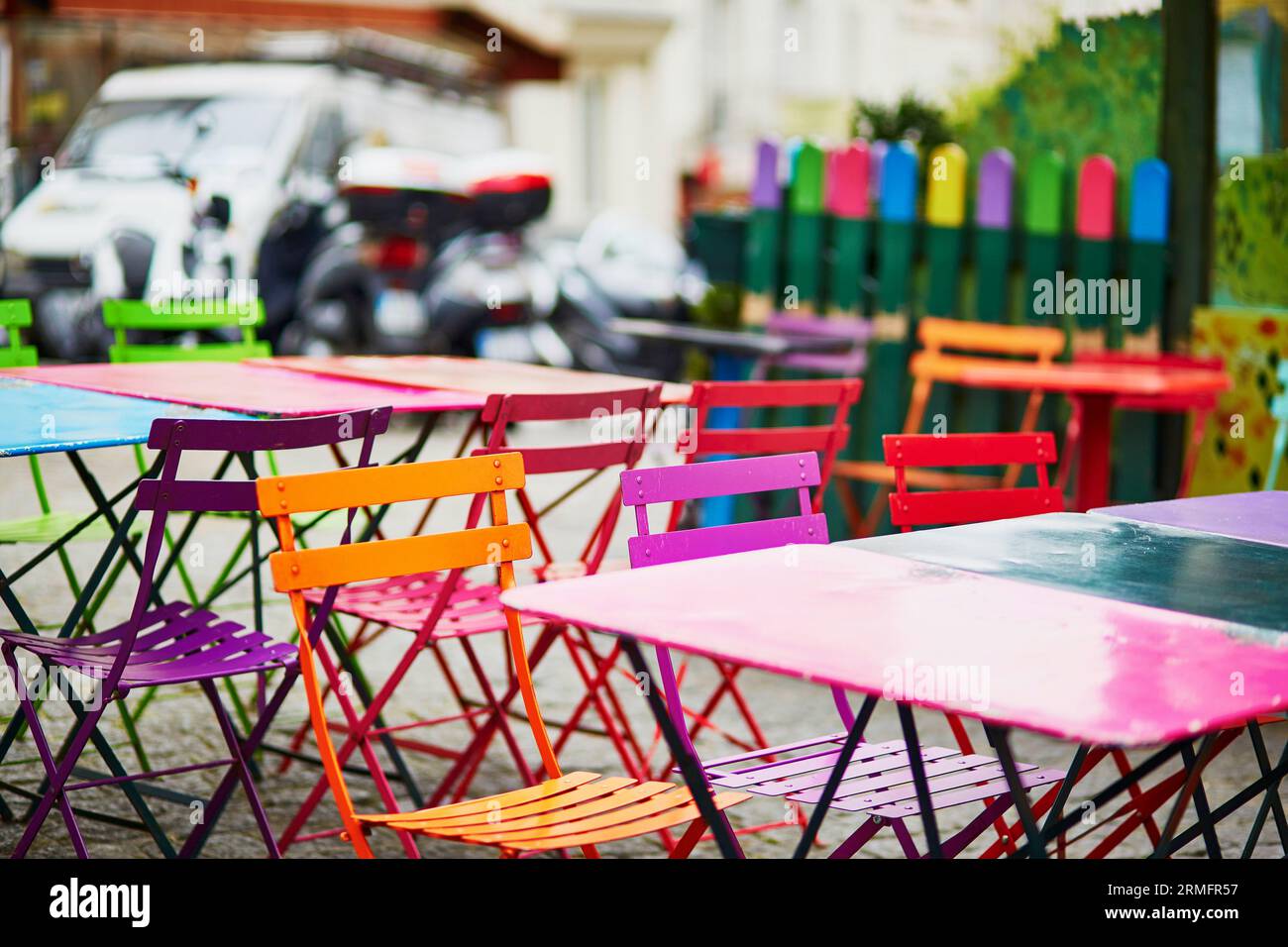 Bright colorful tables of an empty Parisian outdoor cafe on Montmartre ...