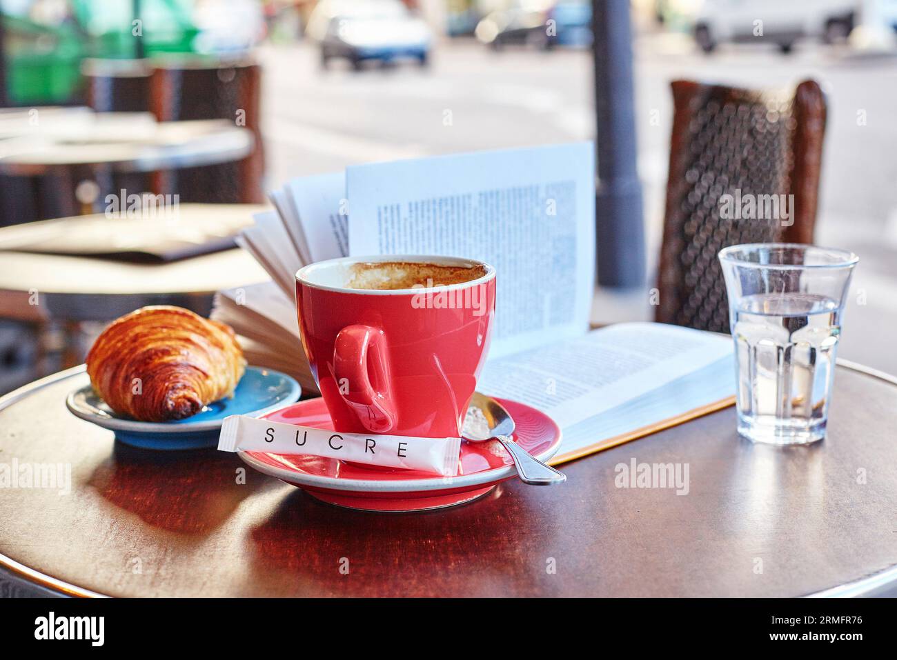 Breakfast in a Parisian street cafe - cup of coffee, croissant and book Stock Photo - Alamy