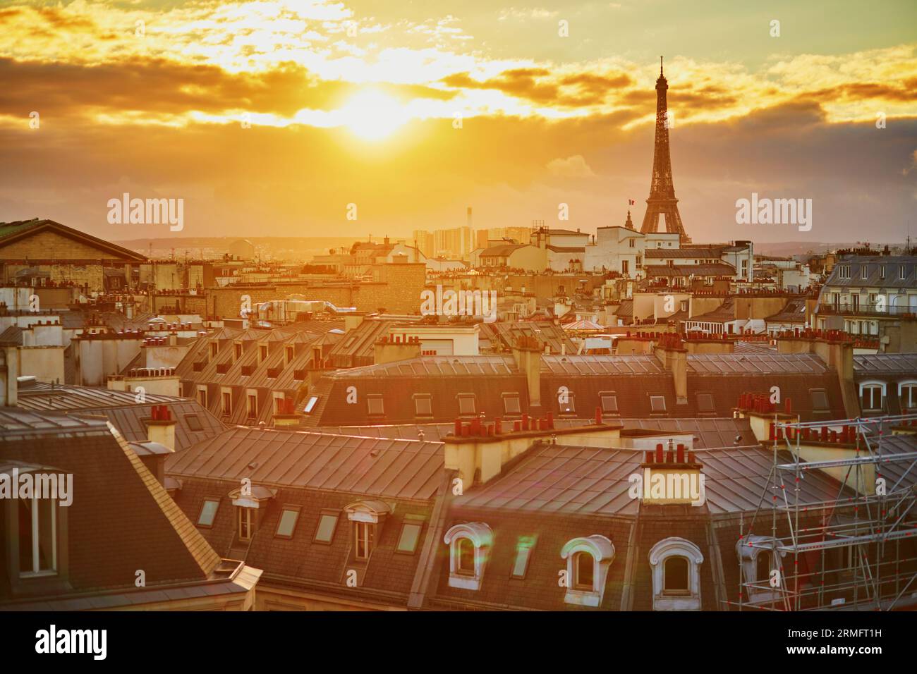 Beautiful Parisian skyline with roofs and dramatic colorful sunset ...