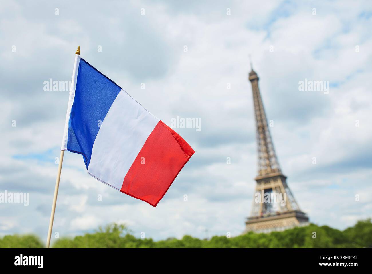 French national flag (tricolour) in Paris with the Eiffel tower in the ...