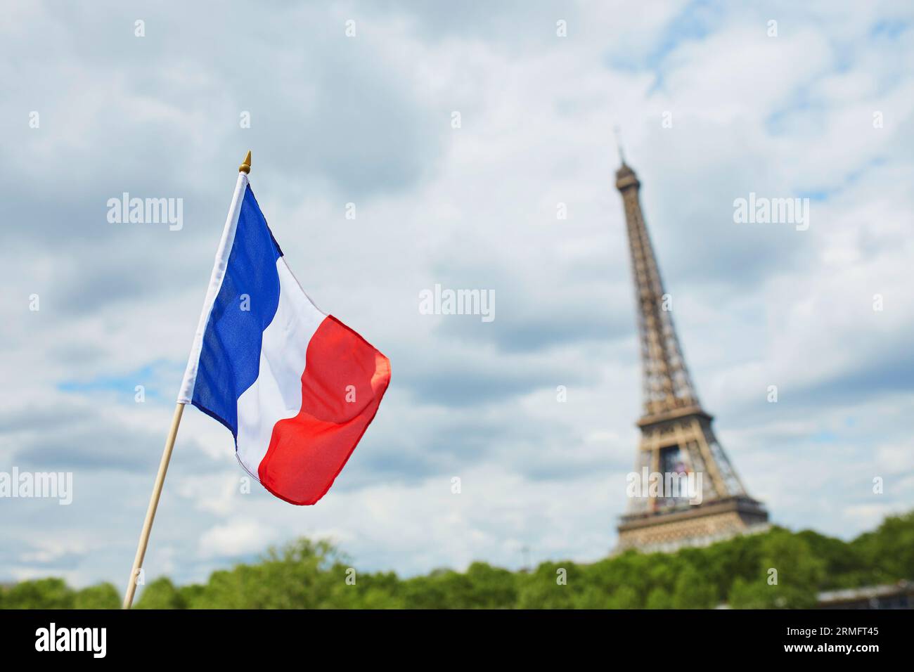 French national flag (tricolour) in Paris with the Eiffel tower in the ...