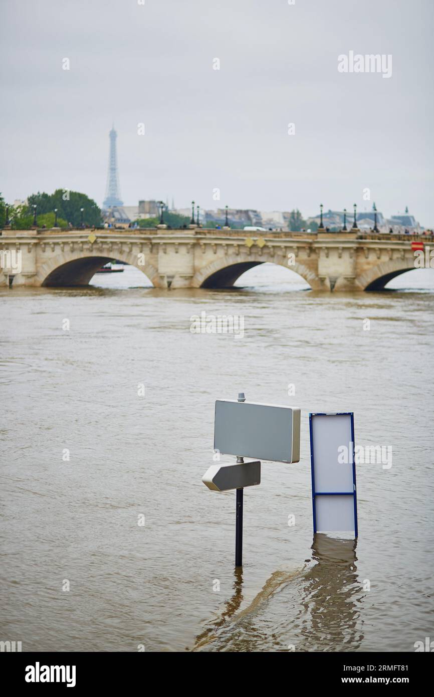 Flood in Paris, extremely high water on the river Seine, road signs ...