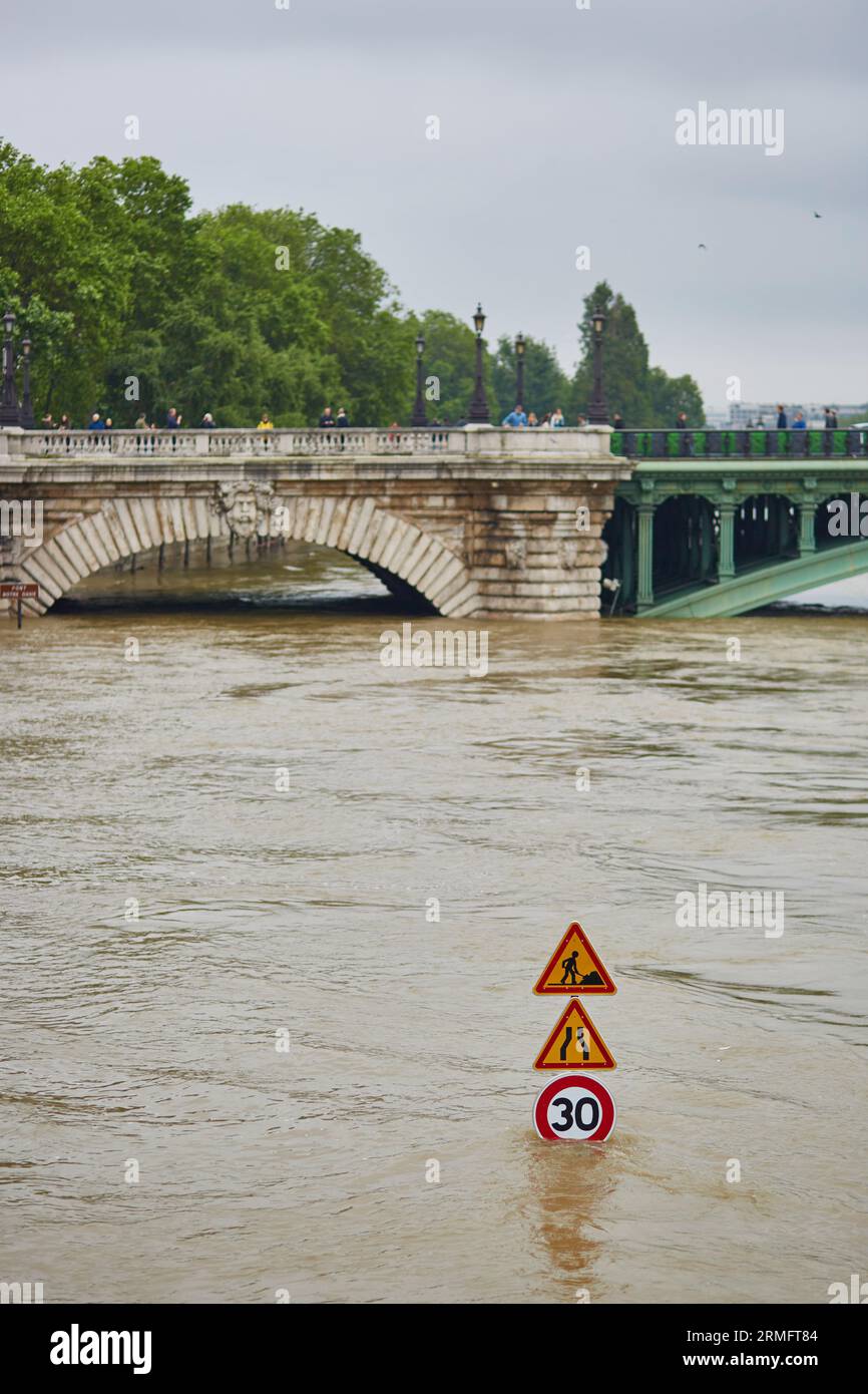 Flood in Paris, extremely high water on the river Seine, road signs ...