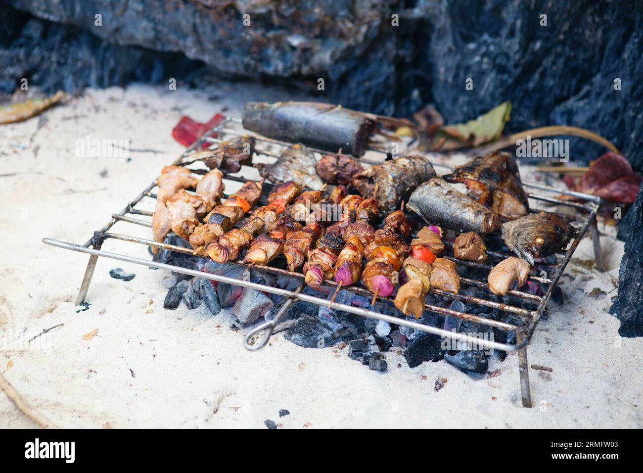 Meet and fresh fish grilled on a beach Stock Photo - Alamy
