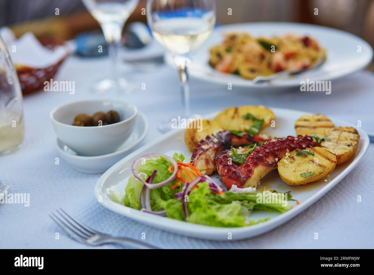 Grilled octopus with baked potatoes in Portuguese seafood restaurant ...