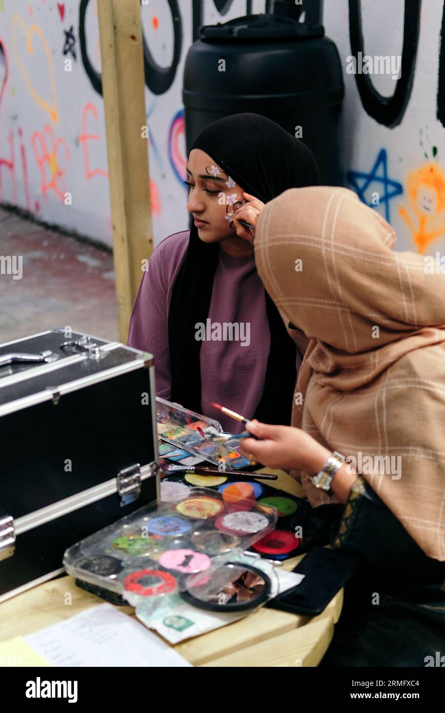 London, UK. 28th August 2023. Volunteers lead a community space, with ...