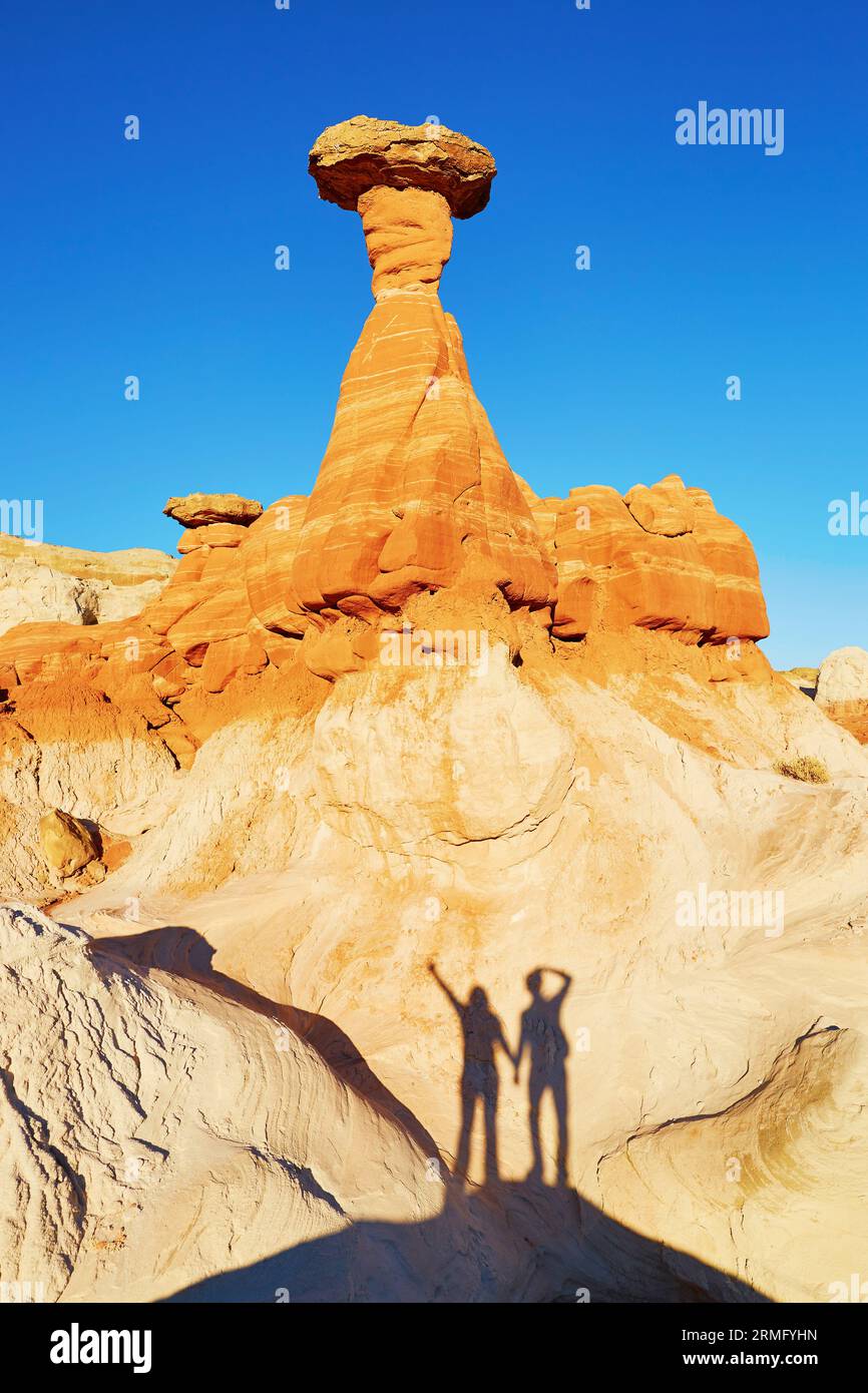 Traveling couple making funny picture of their shadow under the giant ...