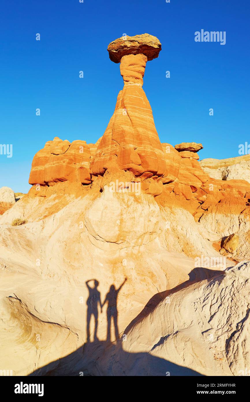 Traveling couple making funny picture of their shadow under the giant ...