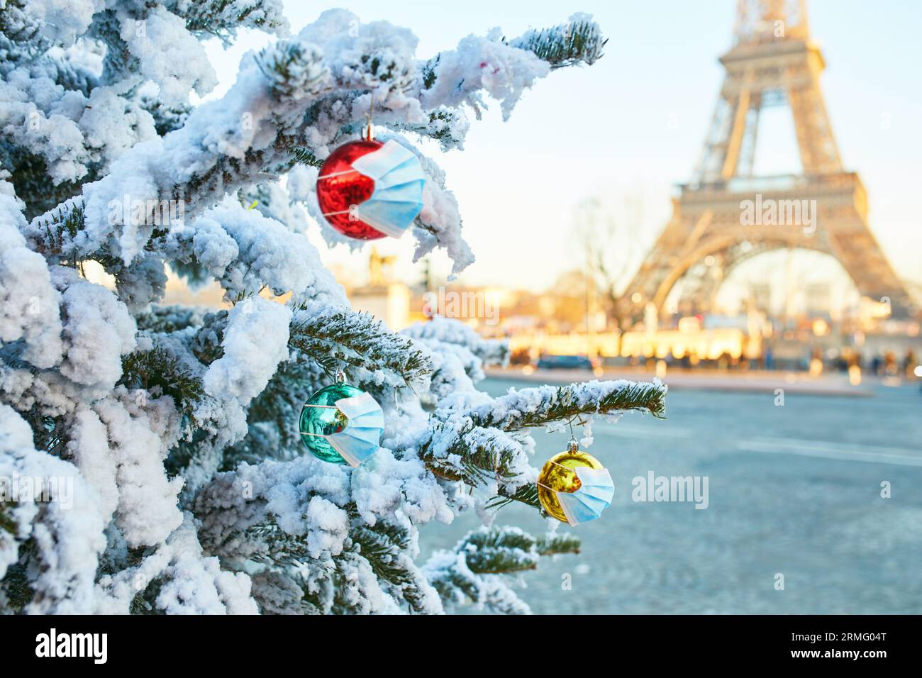 Christmas tree covered with snow and decorated with red, green and ...