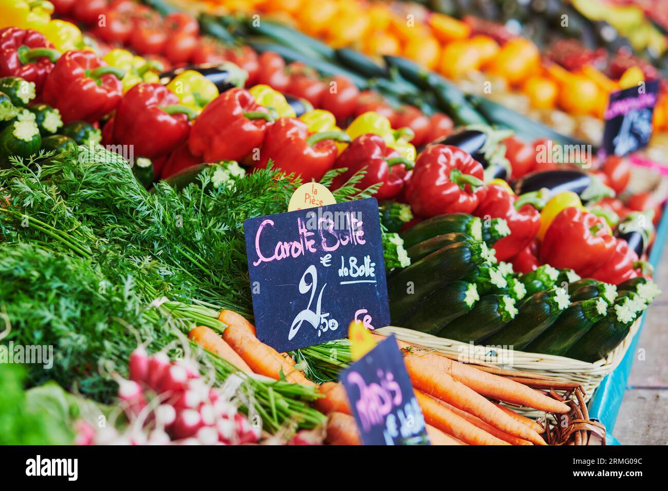 Fresh organic vegetables and fruits on farmer market in Paris, France. Typical European market ...