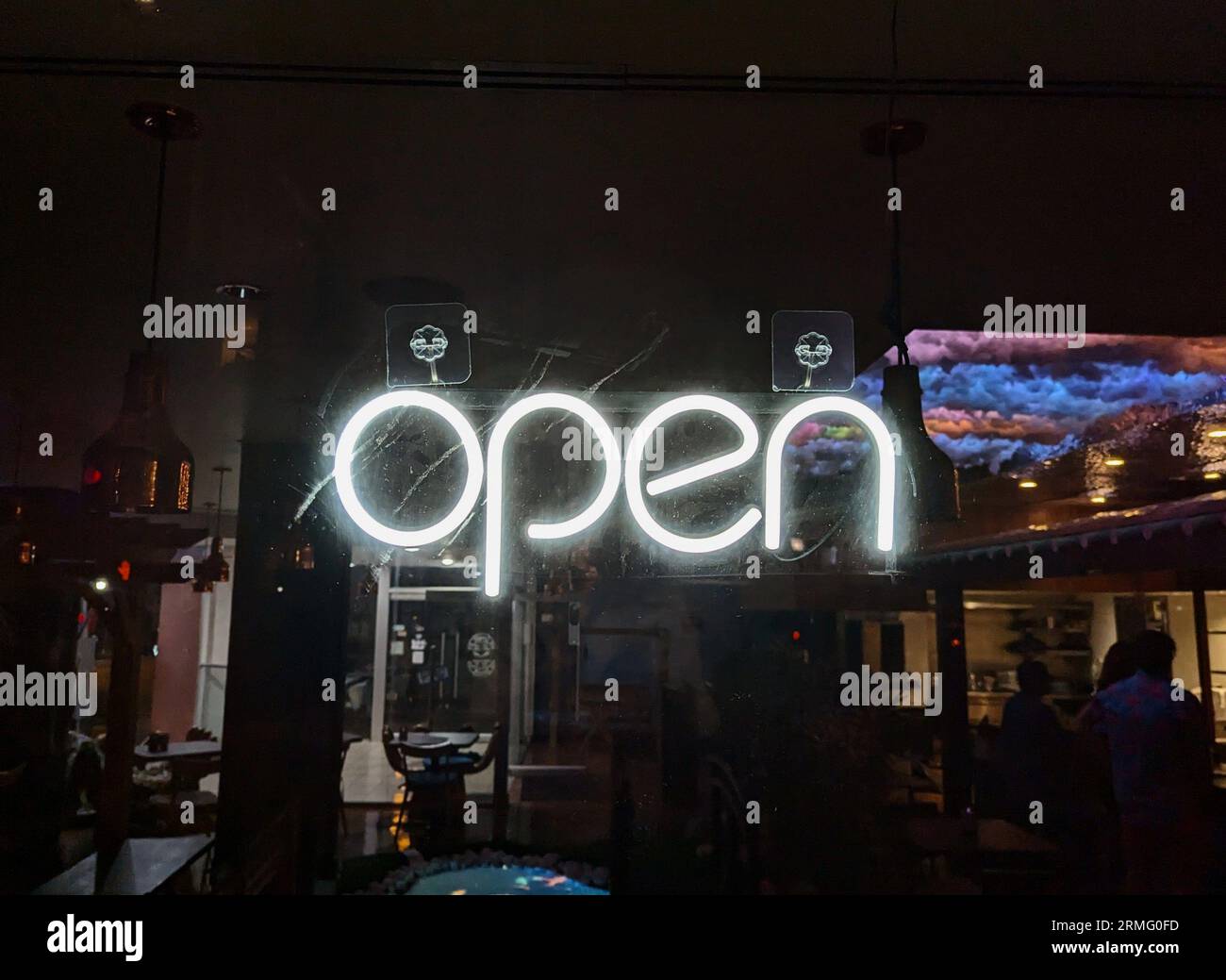 "Open" neon sign hanging in a restaurant window Stock Photo - Alamy