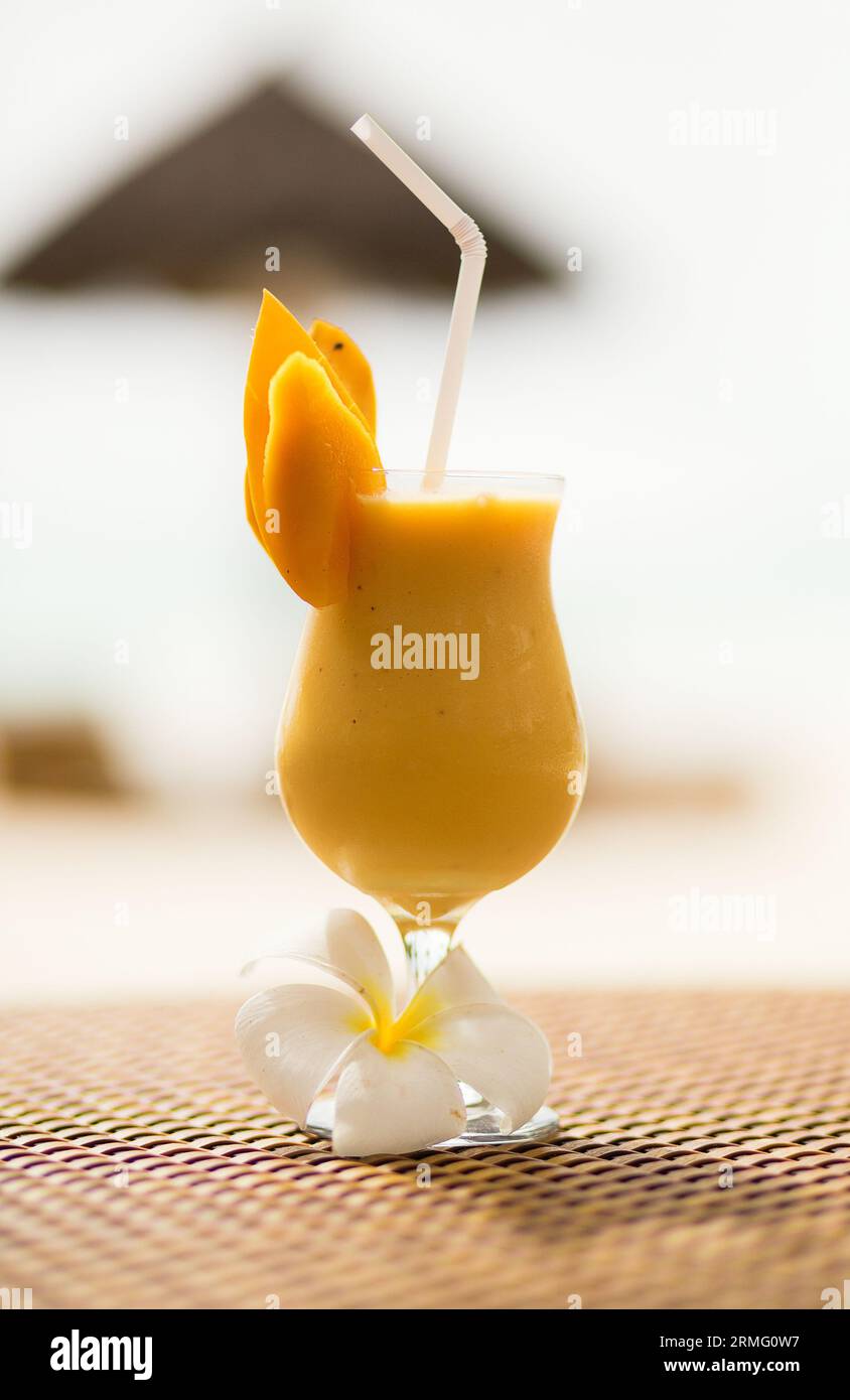 Fresh mango juice on a tropical beach Stock Photo - Alamy
