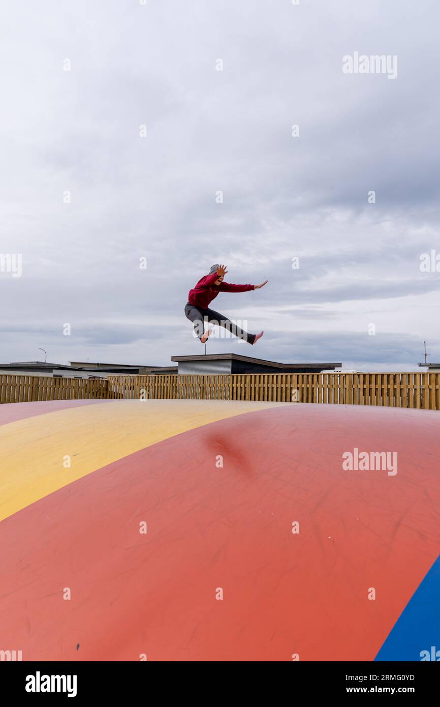 Adult woman jumps on a trampoline jumping balloon in Iceland on a ...
