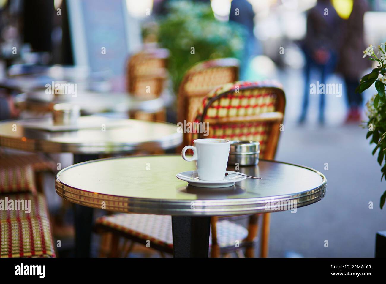Coffee cup on a table of typical Parisian outdoor cafe Stock Photo - Alamy