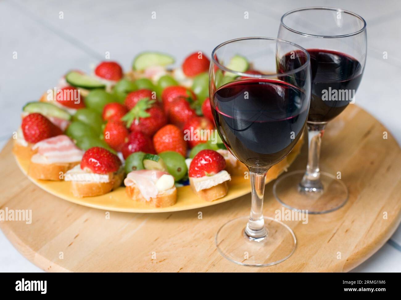 Romantic dinner for two. Red wine, delicious canapes and fruits. Focus ...
