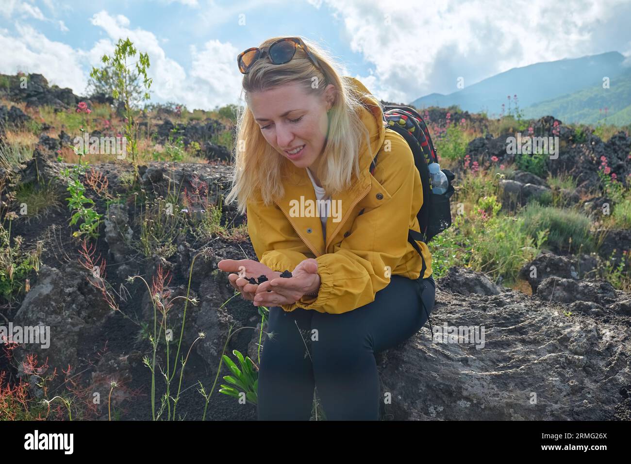Hiking on tallest volcano in Continental Europe - Etna. Smiling young ...
