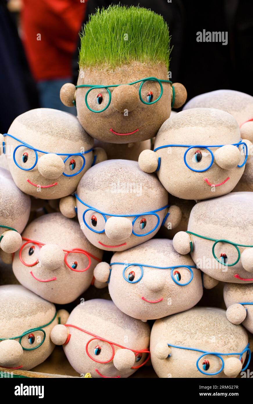 Funny souvenir bags with ground and grass seads in form of human faces ...