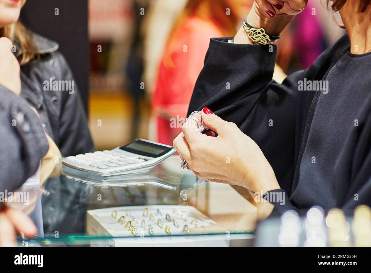 Jeweler helping client to choose a wedding ring Stock Photo - Alamy