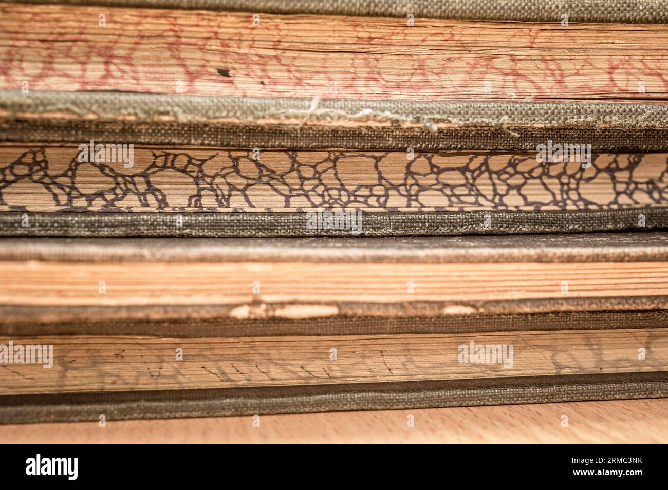 A collection of vintage hardcover books, with faded and aged pages ...