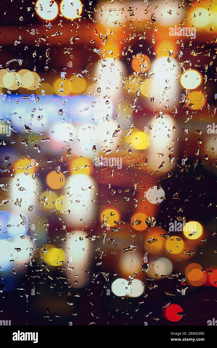 abstract background autumn rain in the night city, drops fall on the ...
