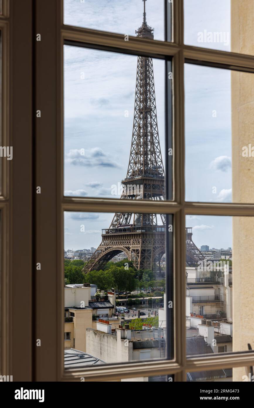 A window with a stunning view of the iconic Eiffel Tower in Paris ...