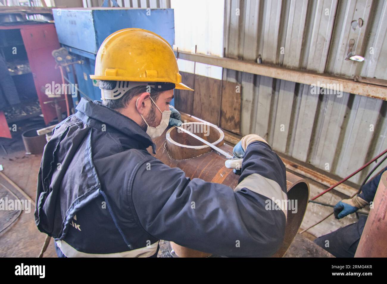 worker does measurement of diameter of a pipe. man doing measurement on ...