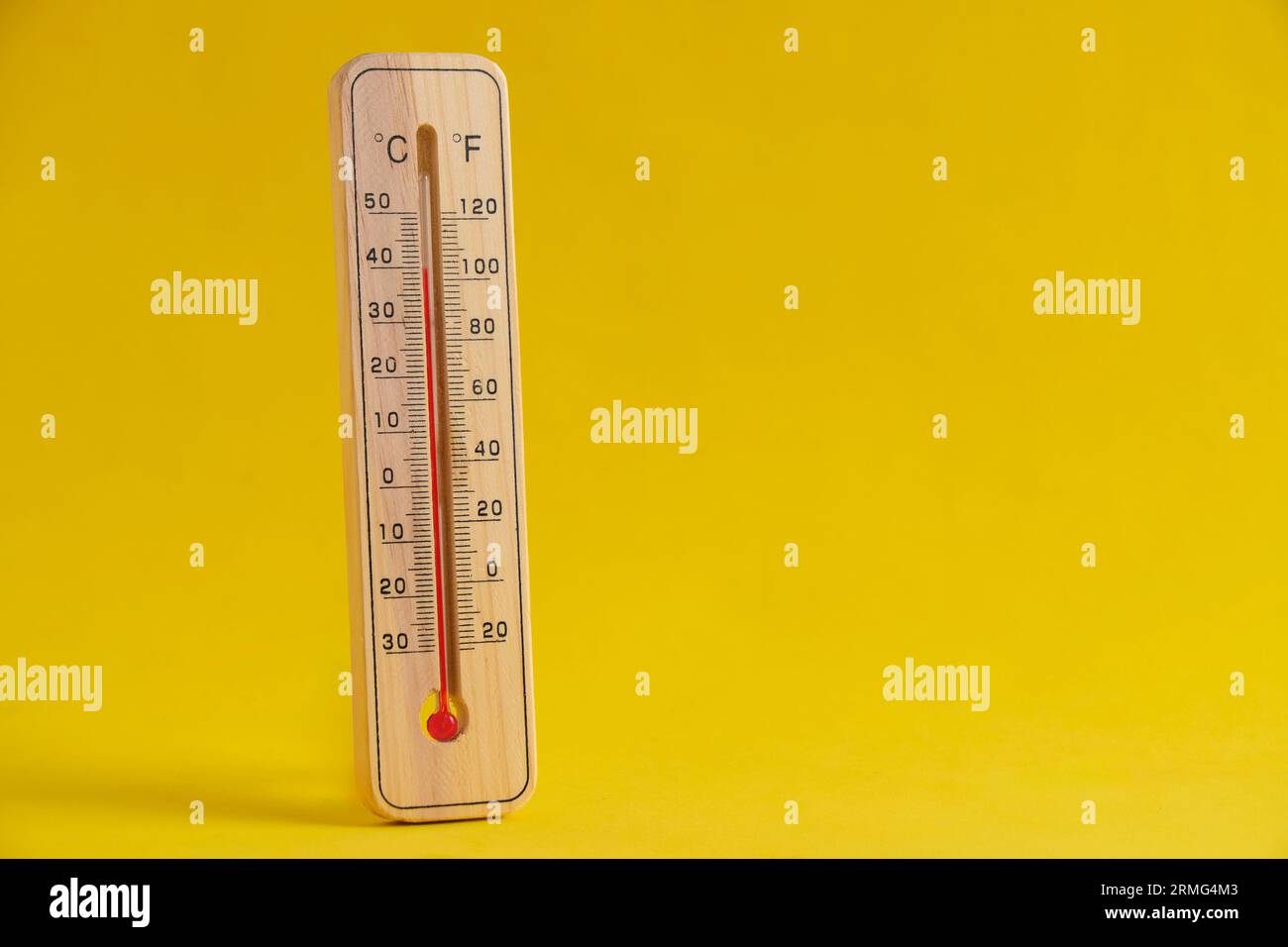 Wooden outdoor thermometer yellow background Stock Photo - Alamy