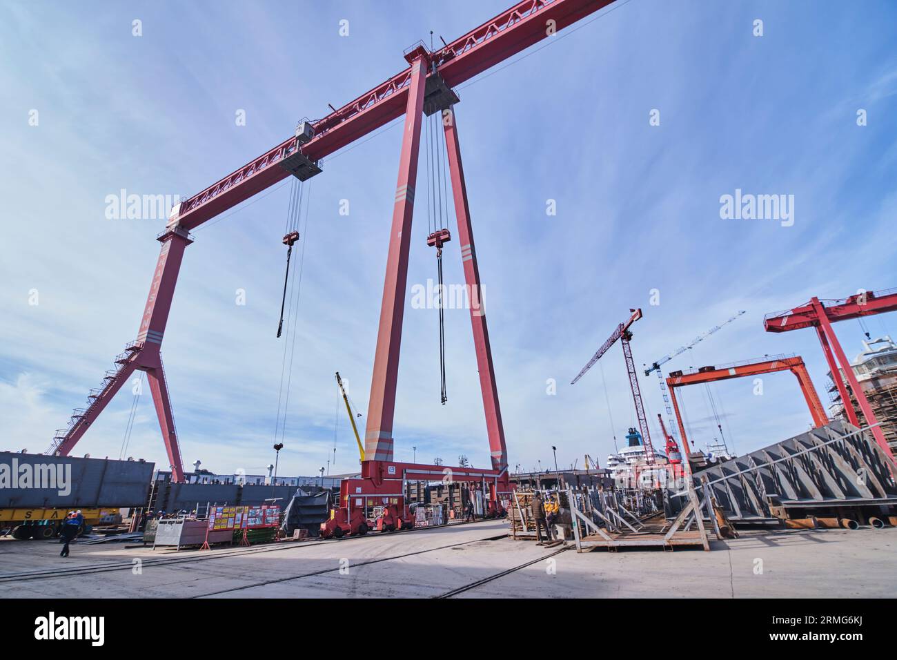 photograph of a big red crane for container ships in a import export ...