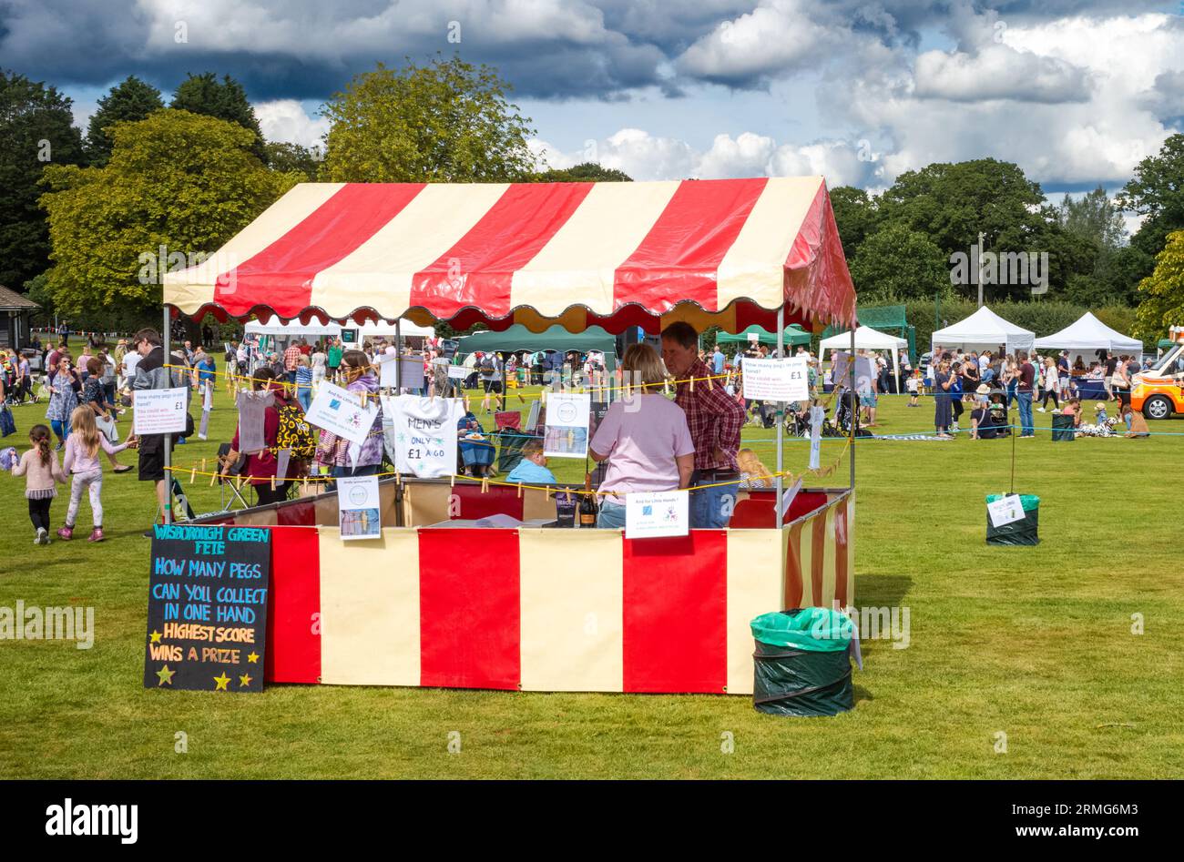 A charity fundraising stall "how many pegs can you collect in one hand ...