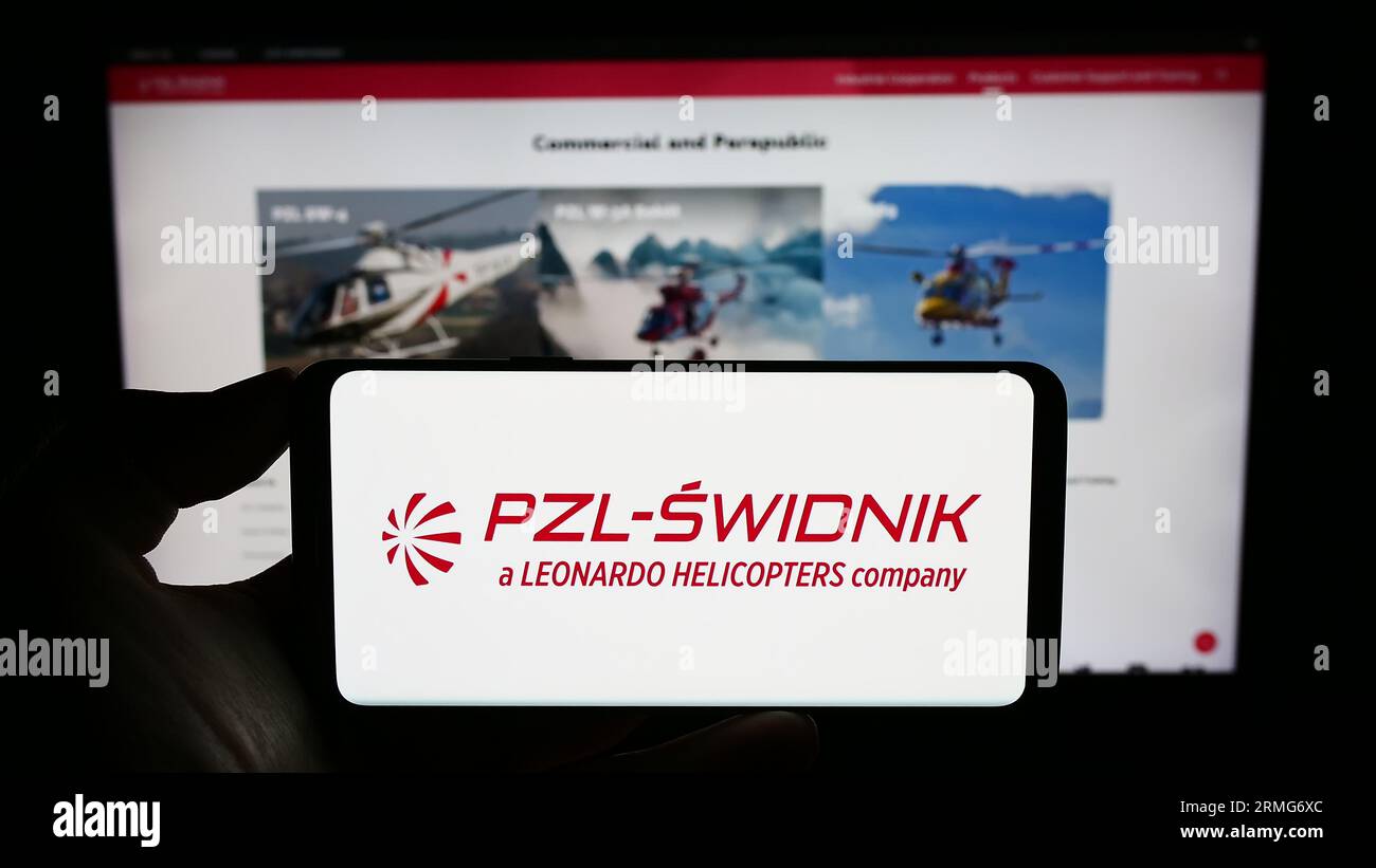 Person holding cellphone with logo of Polish defence company PZL ...