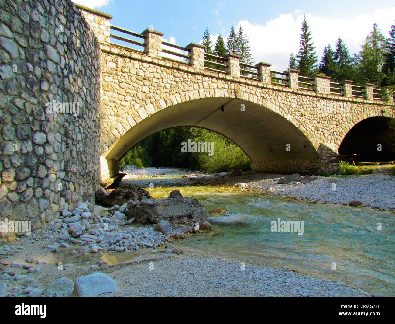 Stone bridge over Krnica river near Kranjska Gora, Slovenia lit by ...