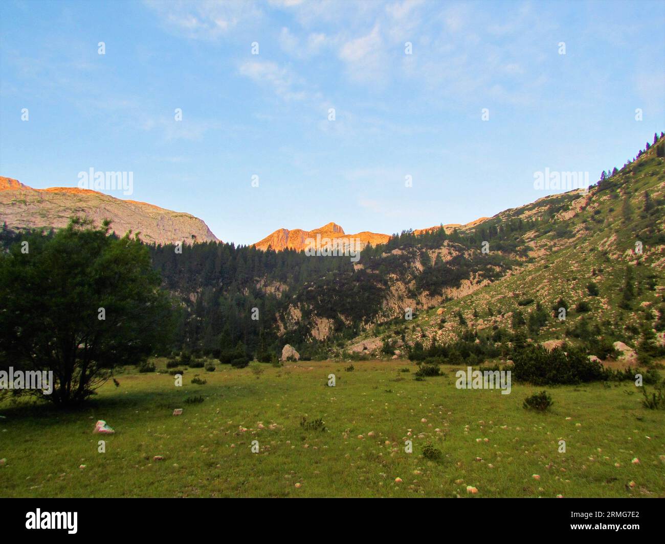 View of Krn mountain from the Krn lake lit by sunshine in early morning ...