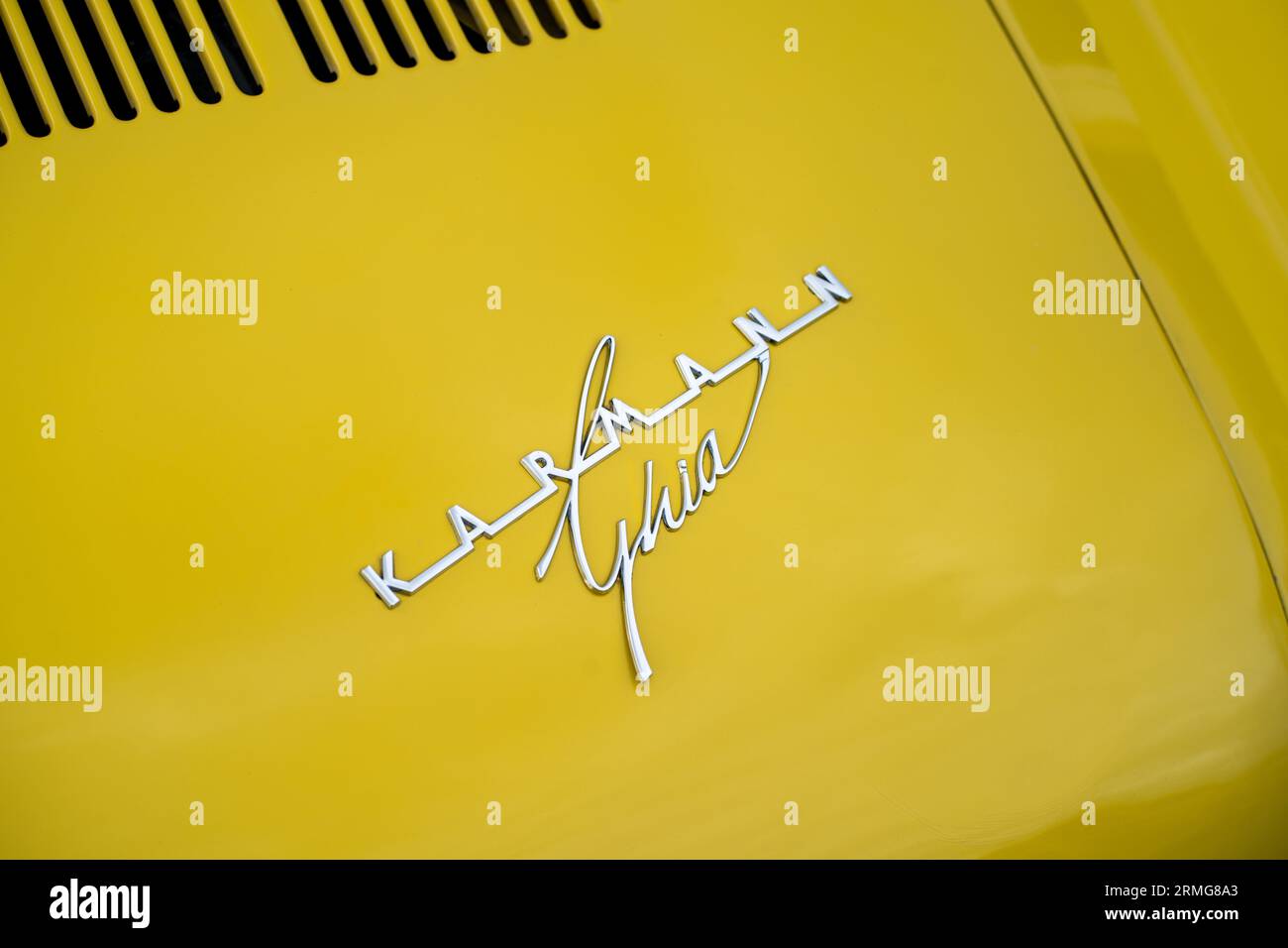 Karmann Ghia Rear Logo Badge on Yellow Paintwork Stock Photo - Alamy