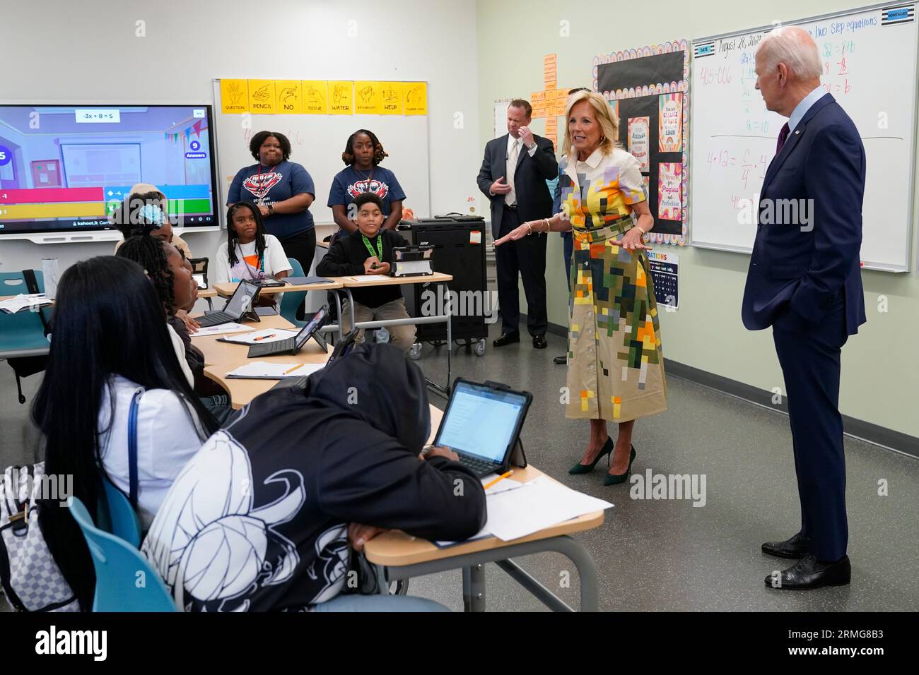 President Joe Biden listens as first lady Jill Biden speaks with ...