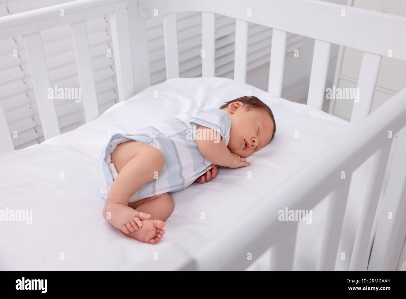 Cute newborn baby sleeping in crib. Bedtime Stock Photo - Alamy