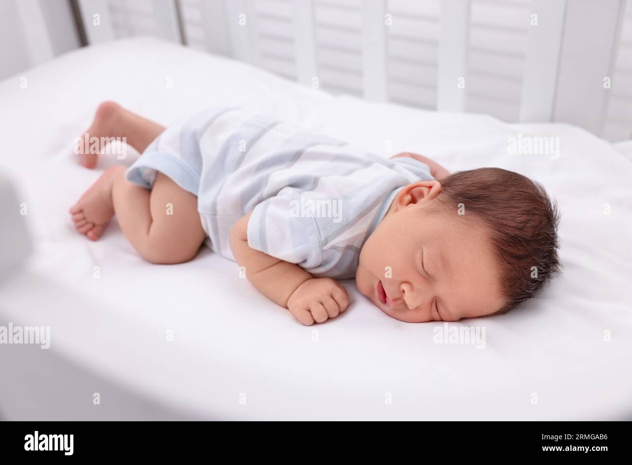 Cute newborn baby sleeping in crib. Bedtime Stock Photo - Alamy