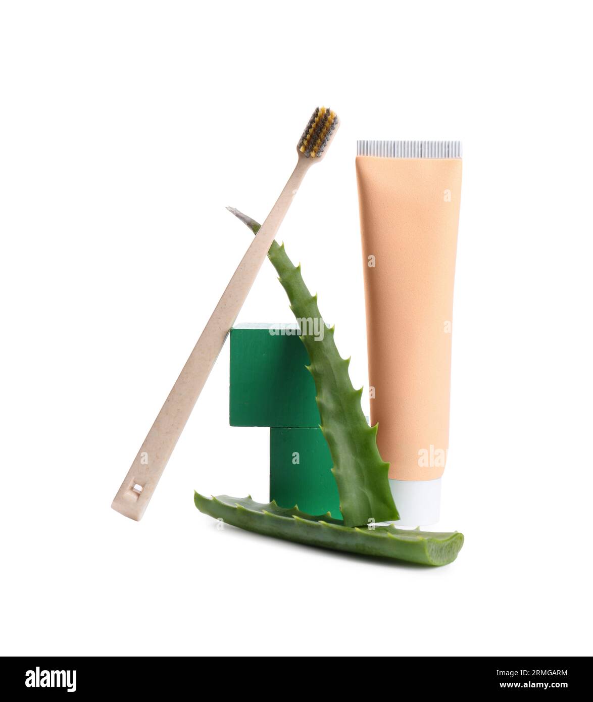 Tube of toothpaste, brush and aloe vera leaves on white background ...