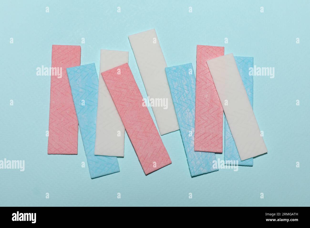 Sticks of tasty chewing gum on light blue background, flat lay Stock ...