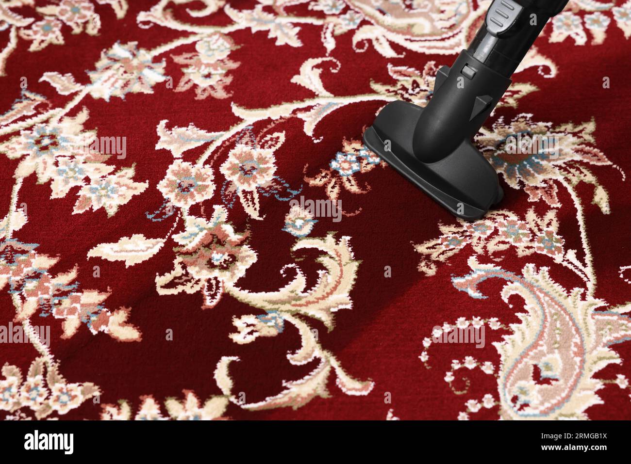 Hoovering carpet with vacuum cleaner, space for text Stock Photo - Alamy